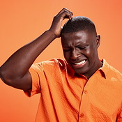 Black man, clueless and thinking with doubt in studio for mistake on a ...