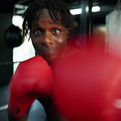 Boxing, fitness and face of black man with gloves in gym with challenge ...