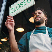 Man, waiter and closed sign with door in cafe for no service, message ...