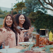 Friends, applause and congratulations at lunch outdoor for conversation ...