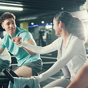 Fist bump, cycling class and group of people in gym for cardio workout ...