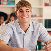 Smile, face and student in high school with writing test, exam or ...