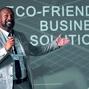 Black man, presenter and mic for presentation on sustainable business ...